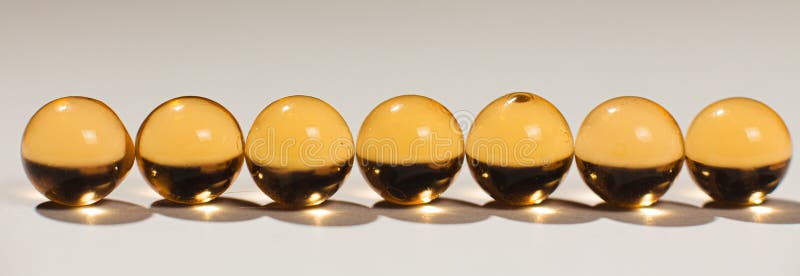 Line of Orange Fish Oil Balls Stock Image - Image of pile, fish: 197258209