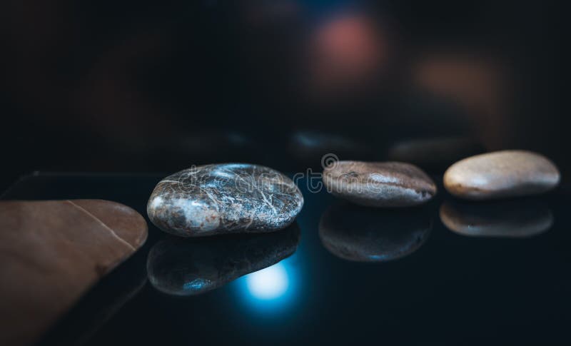 Line of Pebbles on a Dark Glowing Surface Stock Photo - Image of ...