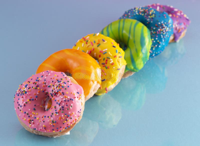 Line of Rainbow Colored Glazed Donuts Stock Image - Image of colorful ...