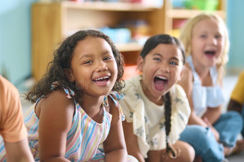 Line of Smiling Primary or Elementary School Students Sitting on Floor ...