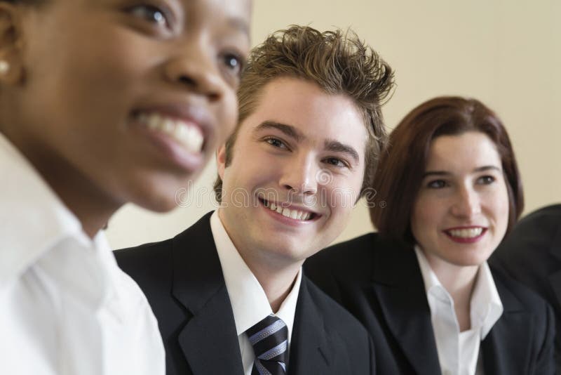 Line of Three Smiling Business People at Meeting. Stock Image - Image ...