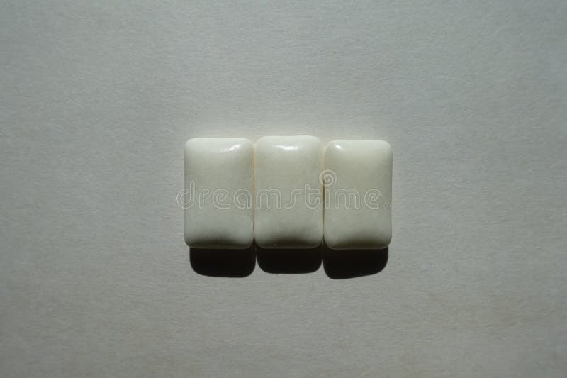 Line of Three White Pieces of Chewing Gum Stock Image - Image of ...