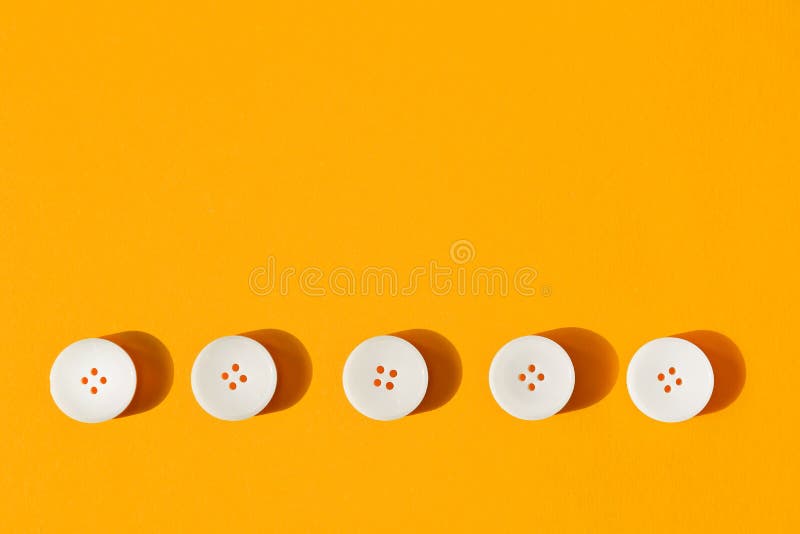 Line of White Buttons on Orange Background, Flat Lay. Space for Text ...