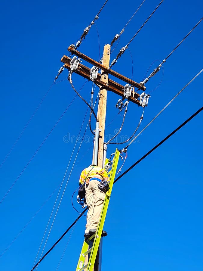 Lineman on Power Pole Near High Tension Wires Stock Image - Image of ...