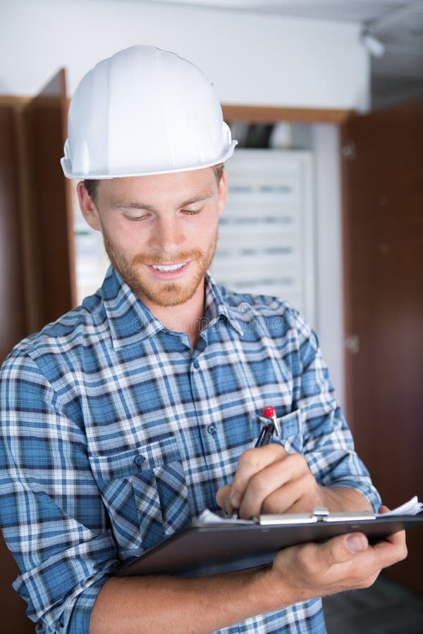 Lineman writing the report stock photo. Image of technician - 261950942