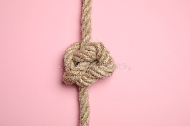 Linen Rope with Knot on Pink Background, Top View. Unity Concept Stock ...