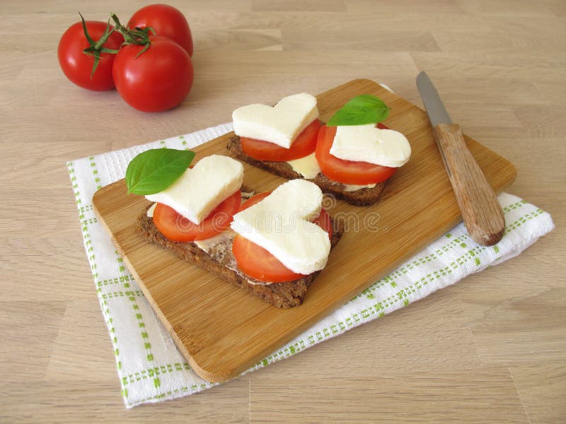 Bread with Tomatoes, Mozzarella Heart and Basil Stock Image - Image of ...