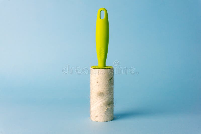 Lint Roller Cleaning Clothes Roller with Trash on a Blue Background ...