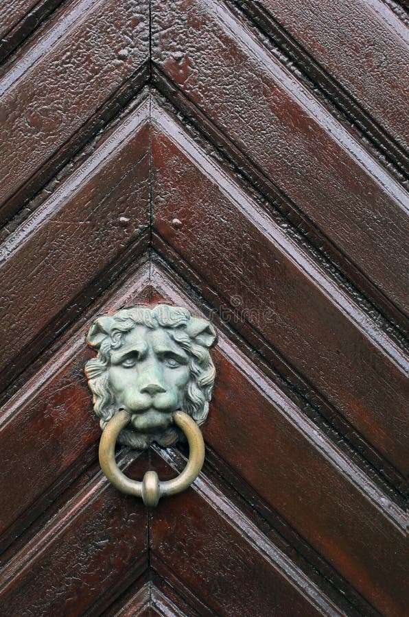 The Lion Head Knocker with the Ring on the Wooden Door Stock Photo ...