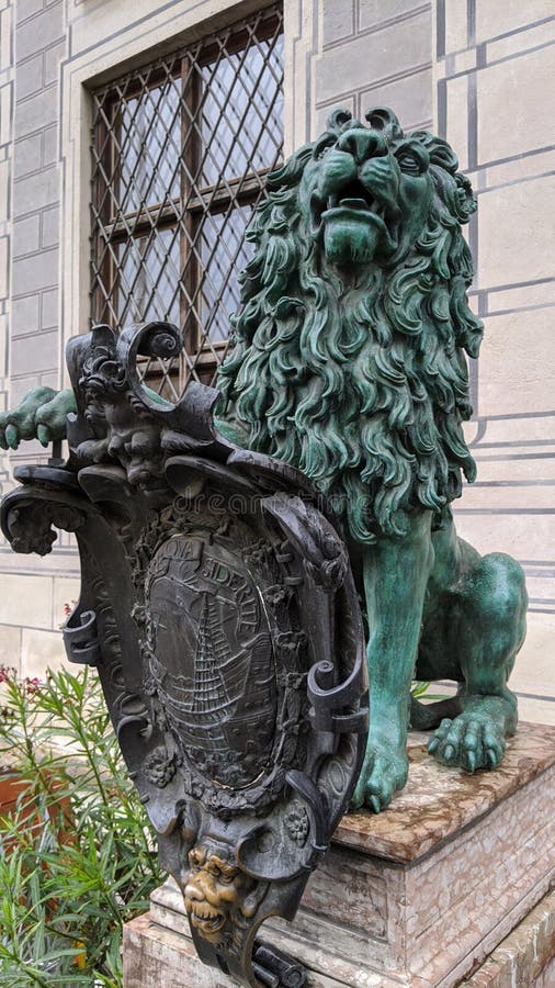 Lion Statue with a Crest in a Paw Stock Photo - Image of history ...