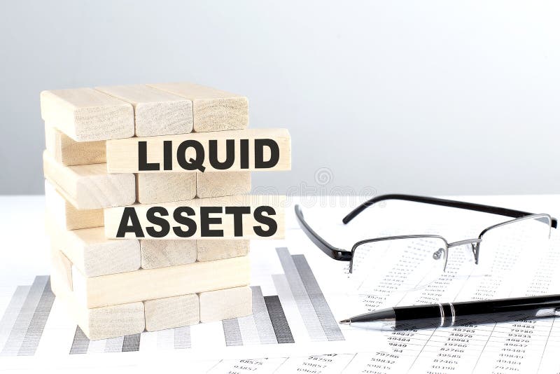LIQUID ASSETS is Written on Wooden Blocks on a Chart Background Stock ...