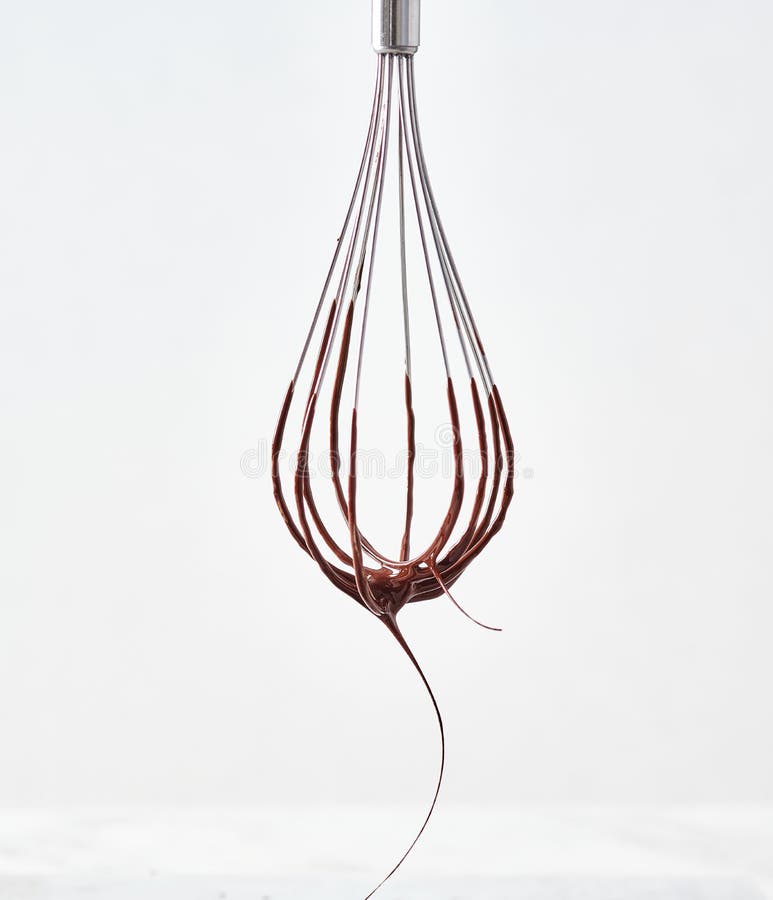 Liquid Chocolate Dripping Off a Whisk, Isolated on White Background ...