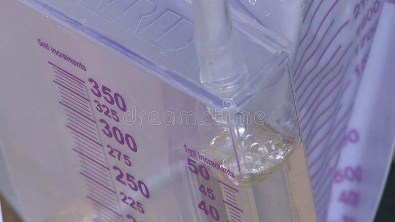 Red Liquid Flows through Spiral Tube in Laboratory Equipment Stock ...