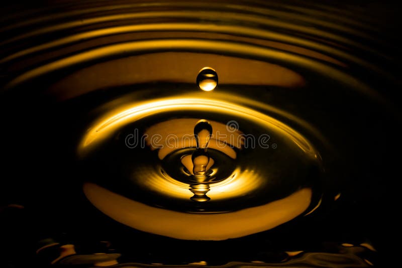 Liquid Gold Drop and Ripple in the Dark Stock Image - Image of metal ...