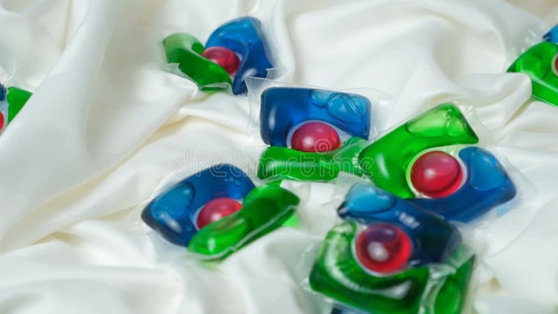 Liquid Laundry Detergent in Capsules Slowly Falling on Fabric Slow ...