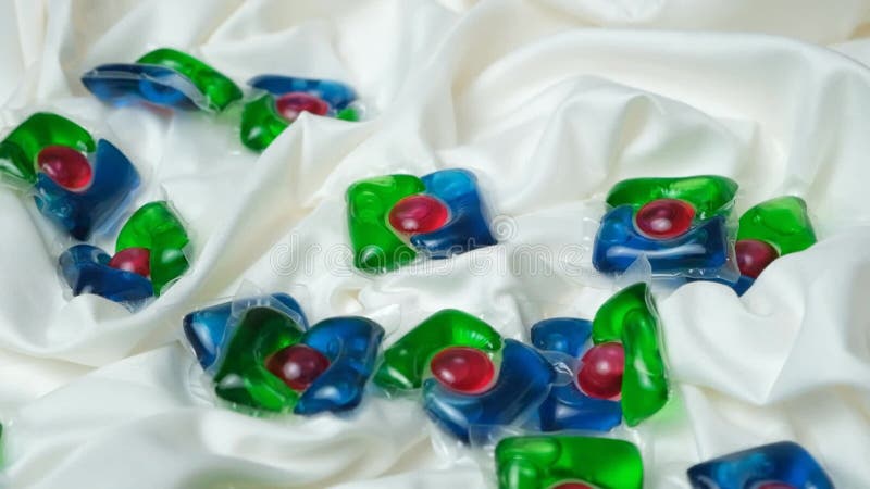 Liquid Laundry Detergent in Capsules Slowly Falling on Fabric Slow ...