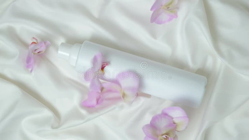 Liquid Laundry Detergent or Fabric Softener on Bedding, Flowers Falling ...