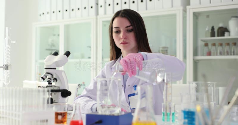Liquid is Poured into Flasks by Assistant in Laboratory Stock Footage ...