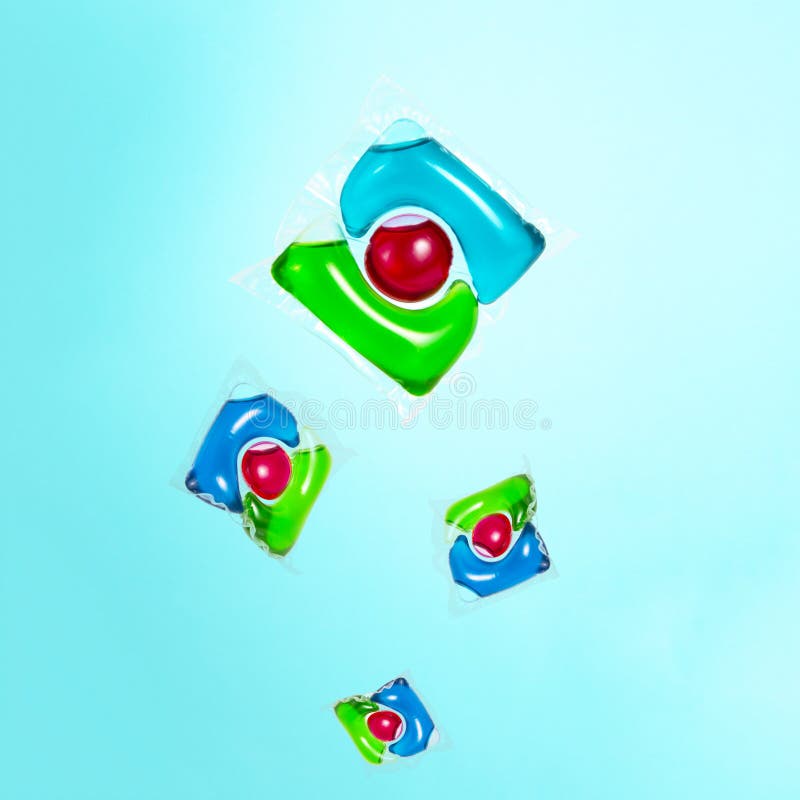 Liquid Powder in Gel Capsule for Washing Multicolor on Blue Background ...