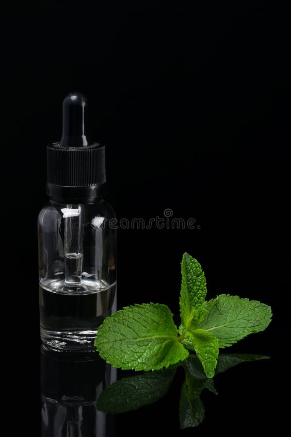 Liquid with a Scent of Green Mint in a Bottle on a Black Background ...