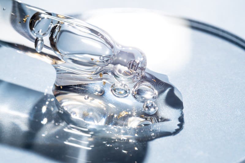 Liquid Serum and Dropper on a Blue Background. 24k Gold Serum Drops in ...