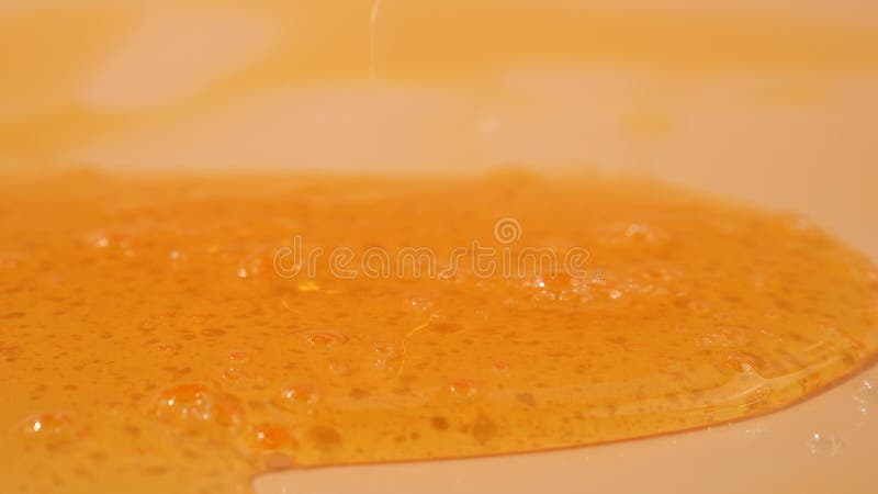 Liquid Shower Gel Flows Gracefully Across a Bright Orange Background ...