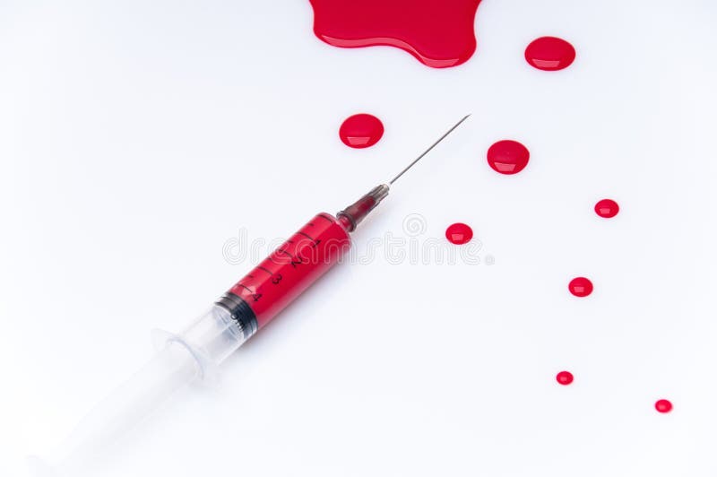 Medical Syringe with Red Blood on a White Background Surrounded by ...