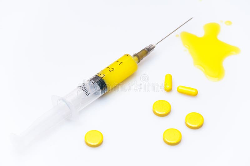 A Medical Syringe with a Yellow Solution Lies on a White Background ...