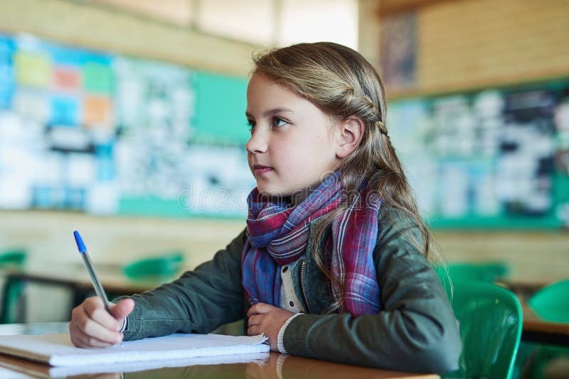 Listening Carefully in Class. Shot of an Elementary School Girl Working ...