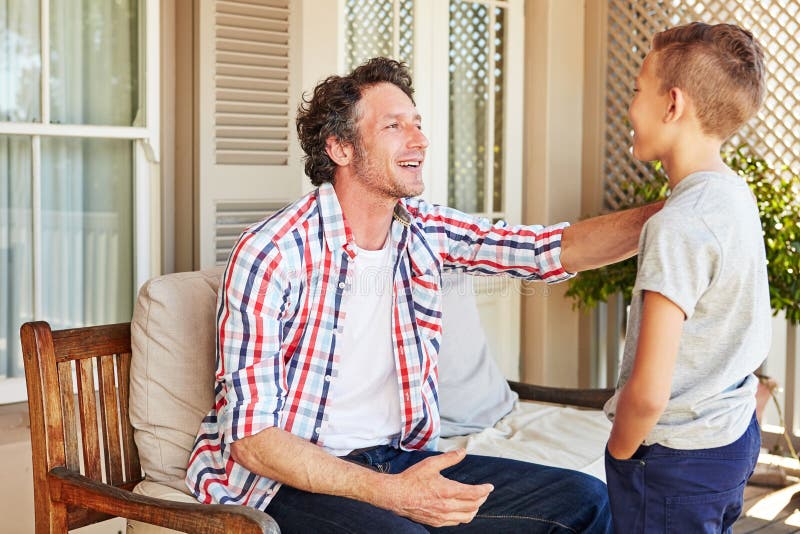Listening To His Father. a Father Talking To His Young Son Outside ...