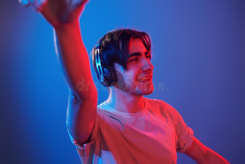 Listening To the Music. Man Standing in the Studio with Neon Light ...