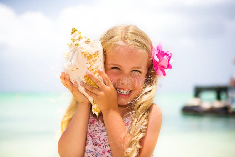 Girl Listening To a Seashell Stock Photo - Image of girl, listening ...
