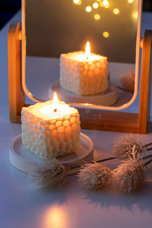 Lit Cube Handmade Soy Candle in Front of a Mirror with Dried Decorative ...