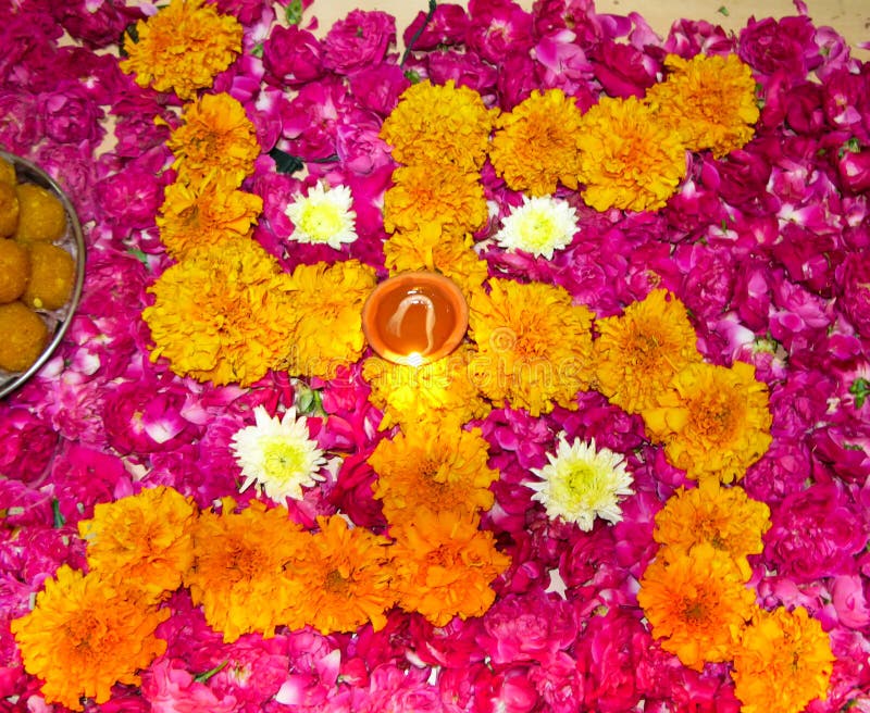 A lit diya on bed of roses stock photo. Image of festival - 6375966