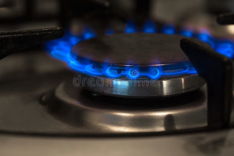 Lit Gas Stove on a Dark Background. Blue Flame of Gas on a Cooker ...