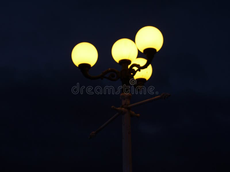 Lit lamp post at night stock photo. Image of insect - 128148218