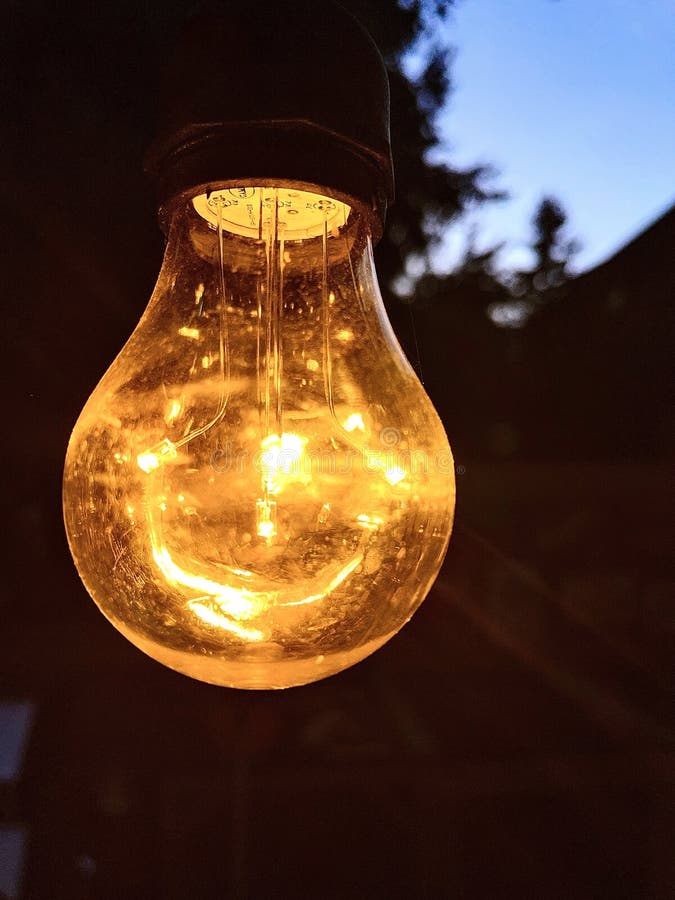 Lit Light bulb at dusk stock photo. Image of turned - 299186130