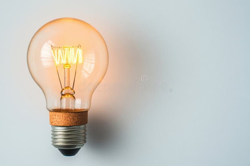 A Lit Light Bulb Mounted on a Wall Illuminating the Space Around it ...