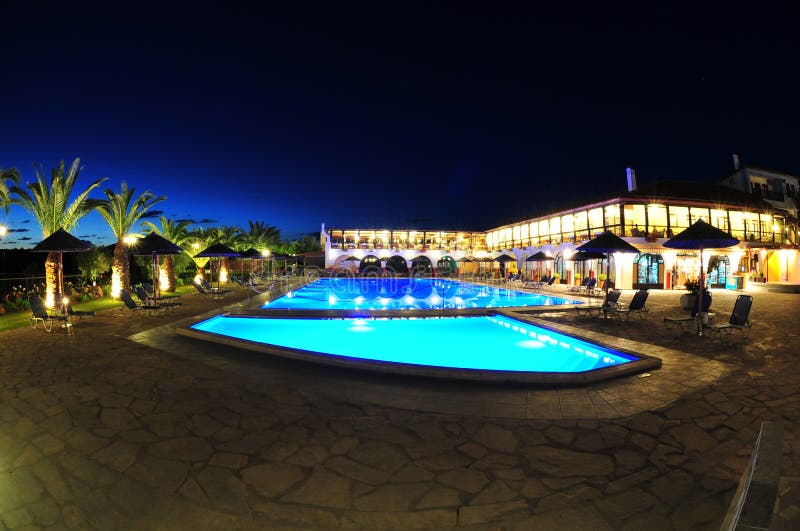 Lit Pool Area of a Resort at Night Stock Photo - Image of mirror, light ...
