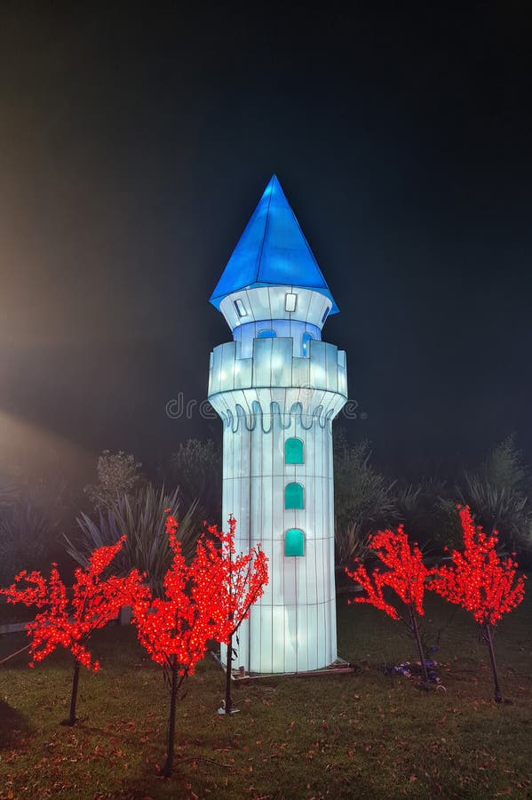 Lit Up Tower and Red Trees in Dark Stock Image - Image of dark, trees ...