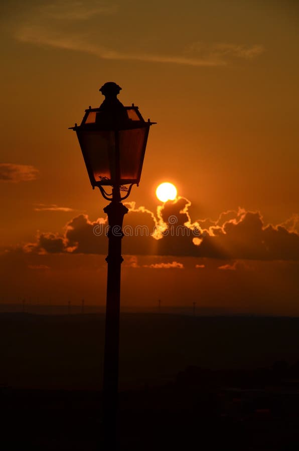 Lit Vertical Lightposts with Sunrise Background Stock Photo - Image of ...