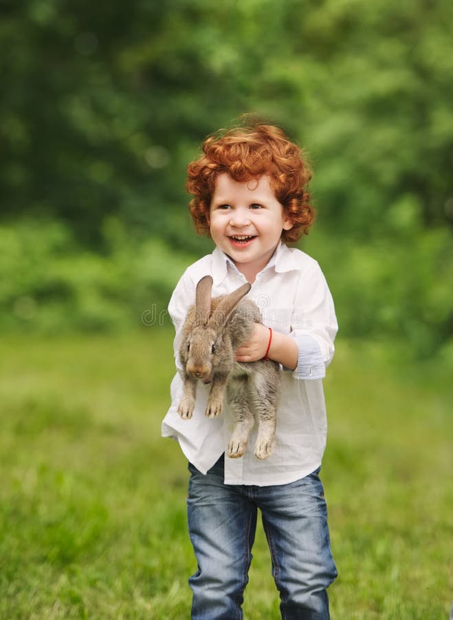 Litle Boy Plays with Rabbit in Park Stock Photo - Image of face, love ...