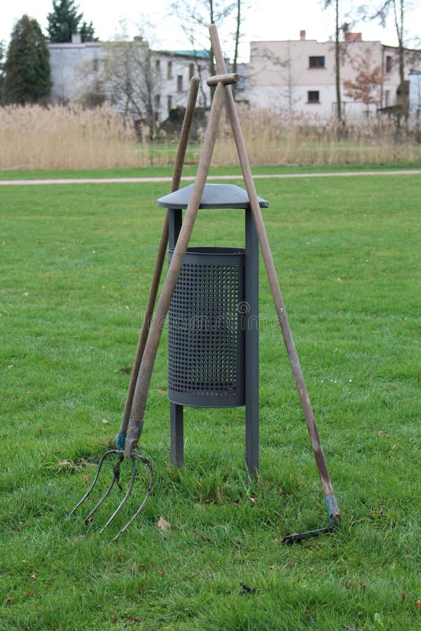 Litter Bin with Rake and Fork Stock Photo - Image of branches, rake ...