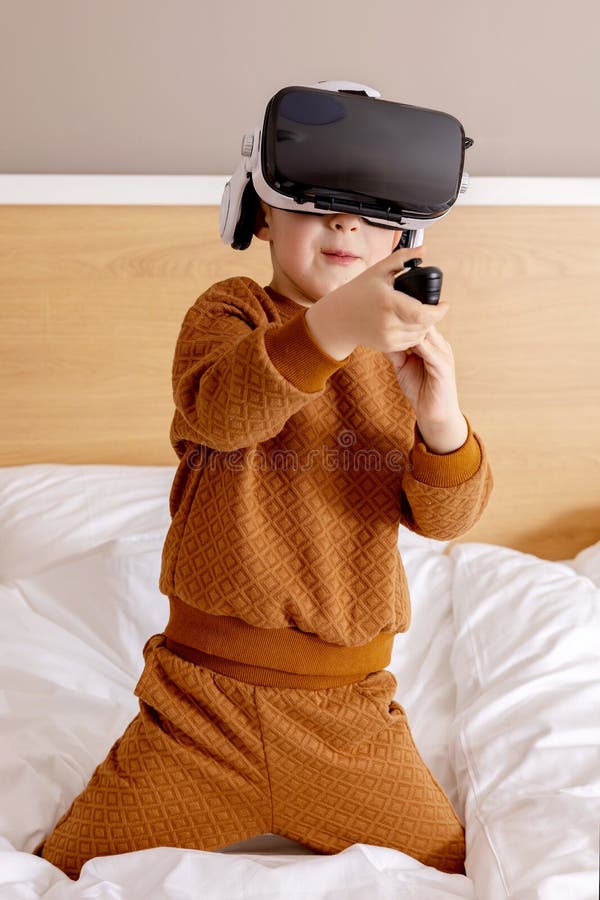 Little Adorable Boy Sitting on Bed at Home with VR Headset and Playing ...