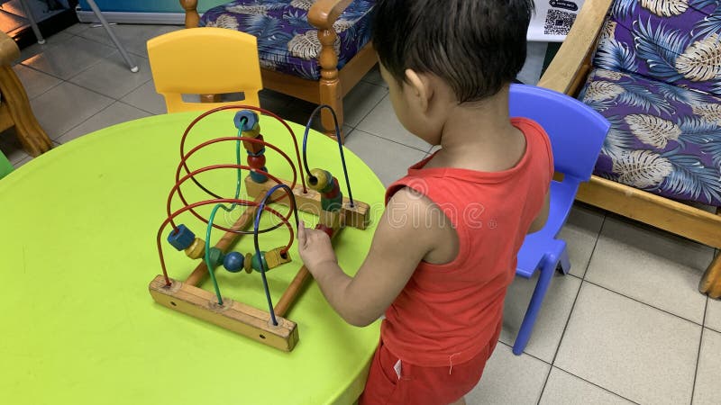 Little Asian Boy Playing Plastic Rings Table Stock Photos - Free ...
