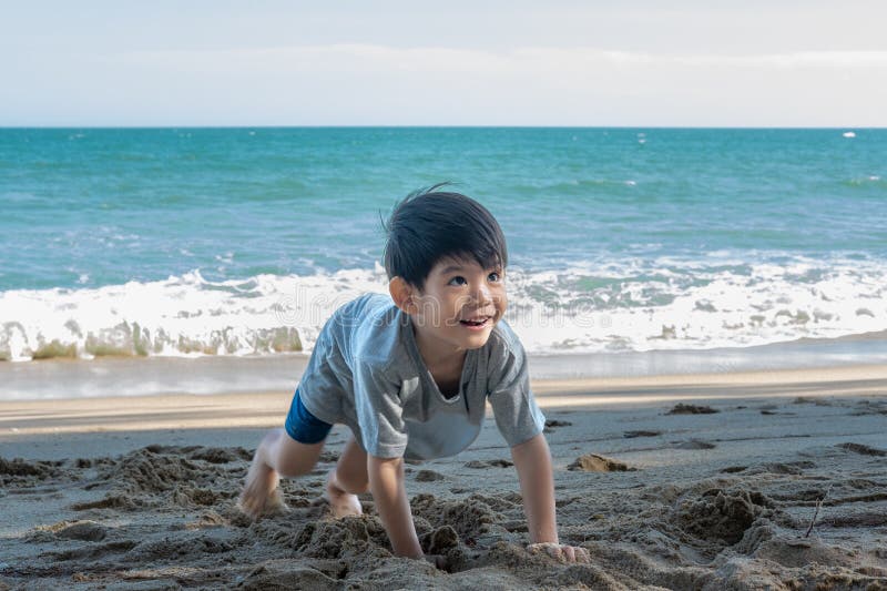 Little Asian Boy Playing in the Sand at the Sea Beach Stock Image ...