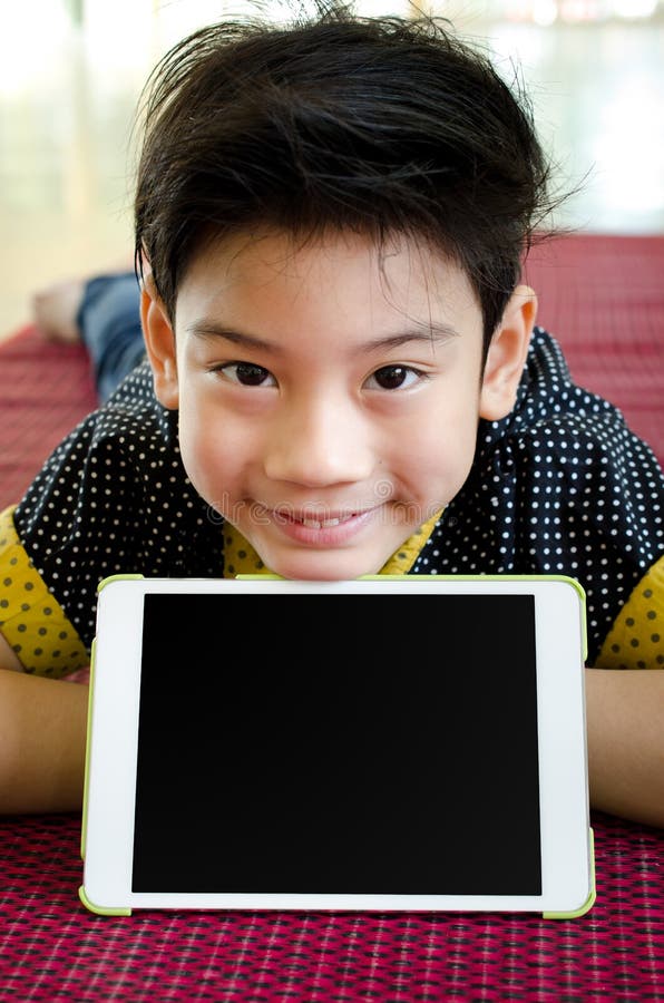 Little Asian Boy Smiles with Tablet Computer Acting on His Face Stock ...