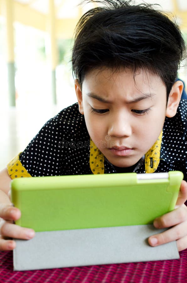 Little Asian Boy Smiles Tablet Computer Acting His Face Stock Photos ...