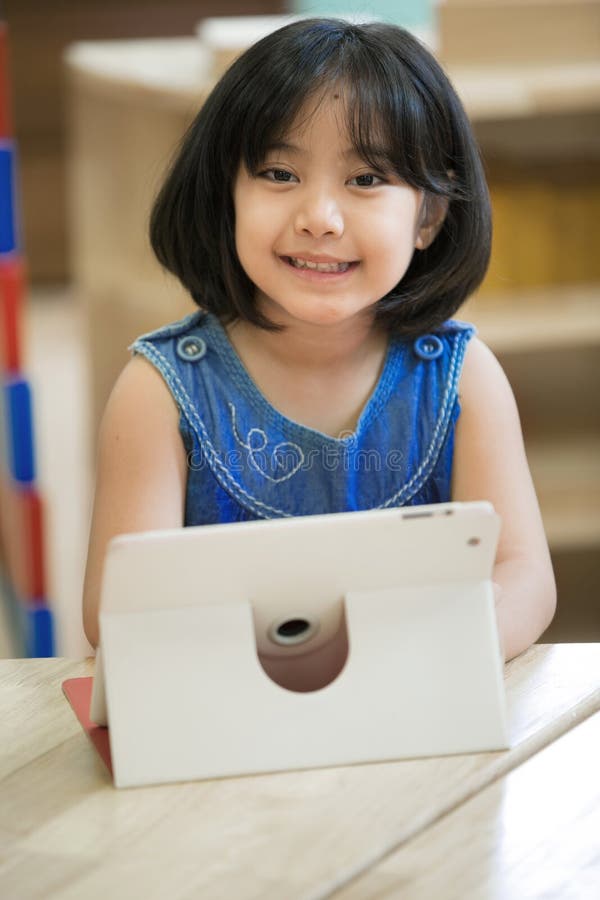 Little Asian Child Playing with a Computer Tablet Stock Photo - Image ...