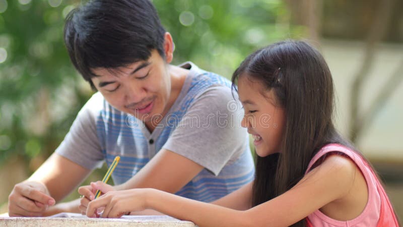 Father with Son Doing Homework in School Book Stock Footage - Video of ...